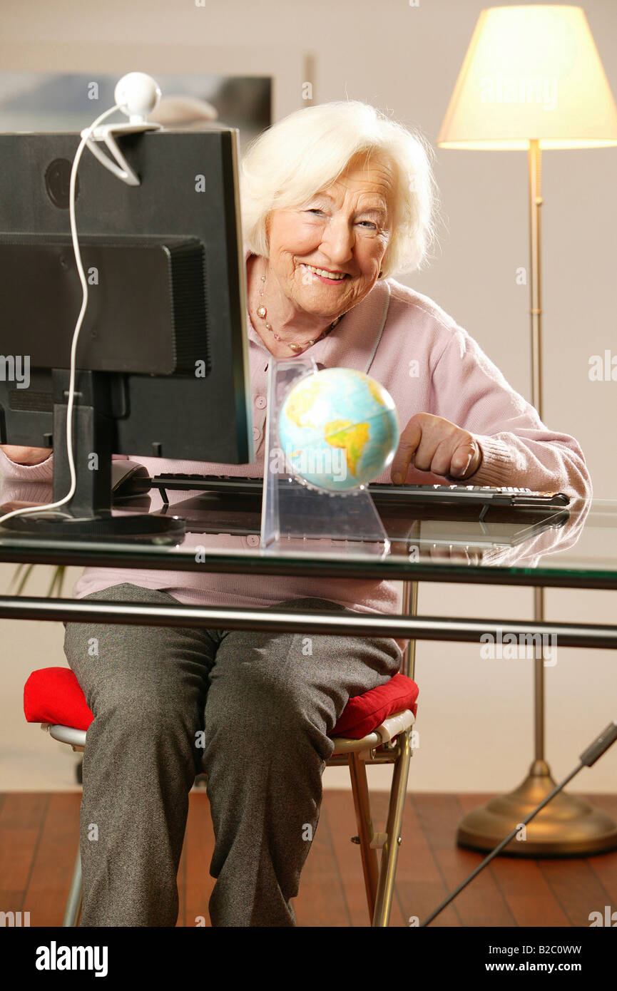 Old woman sitting in front of a computer, Internet telephony Stock ...