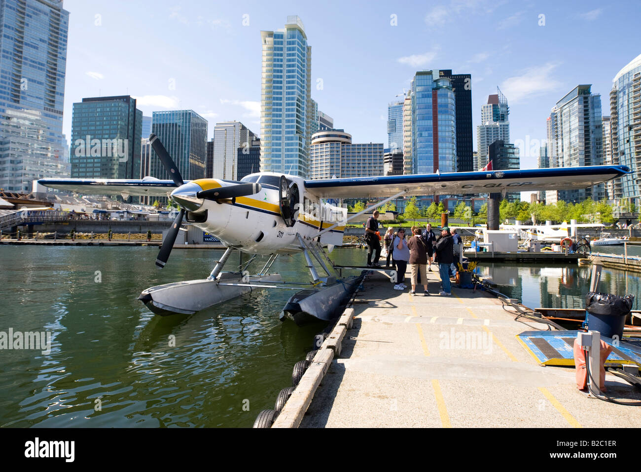Seaplane tied to jetty, at back the high-rise buildings of Coral ...