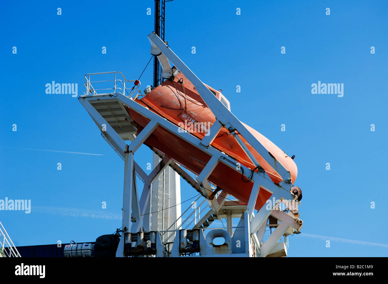 Modern lifeboat on a cargo ship, at Luebeck Harbour, Schleswig-Holstein ...