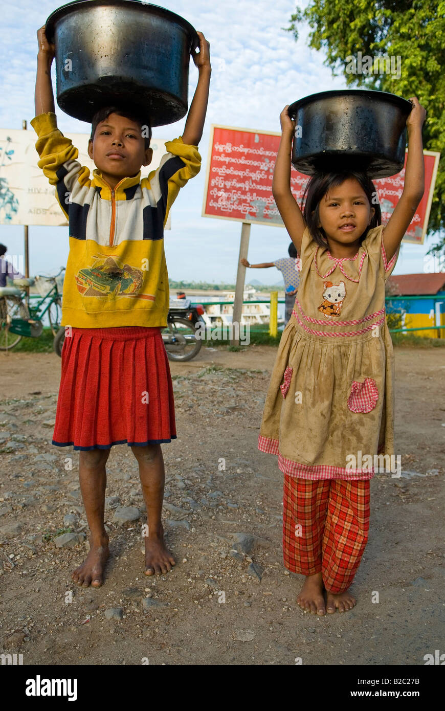 Child looking at two water containers hi-res stock photography and ...