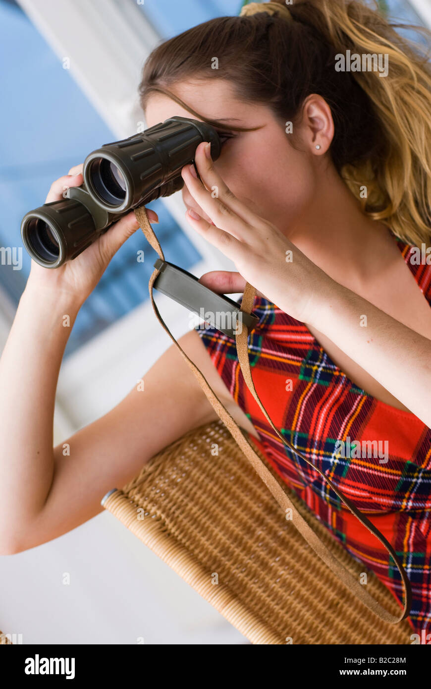 Young attractive woman with binoculars Stock Photo - Alamy