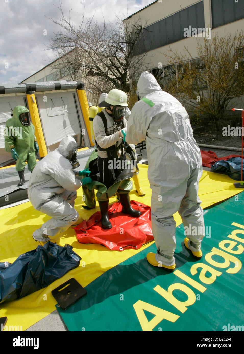 Fire brigade's mobile decontamination tent, firemen wearing hazmat ...