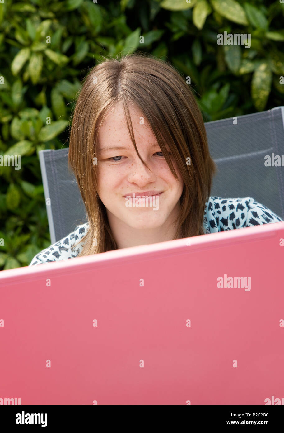 YOUNG GIRL USING A LAPTOP COMPUTER IN GARDEN UK Stock Photo - Alamy