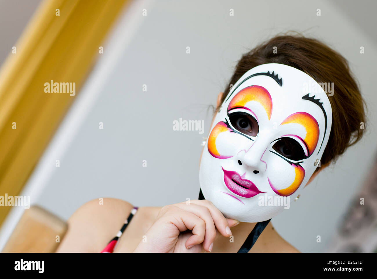 young woman behind mask Stock Photo - Alamy