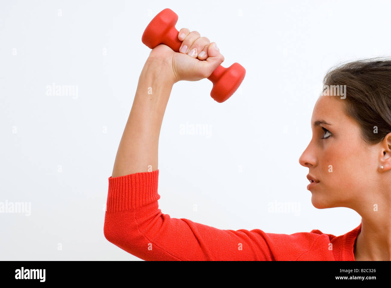 Young woman, side-face, with barbell Stock Photo - Alamy