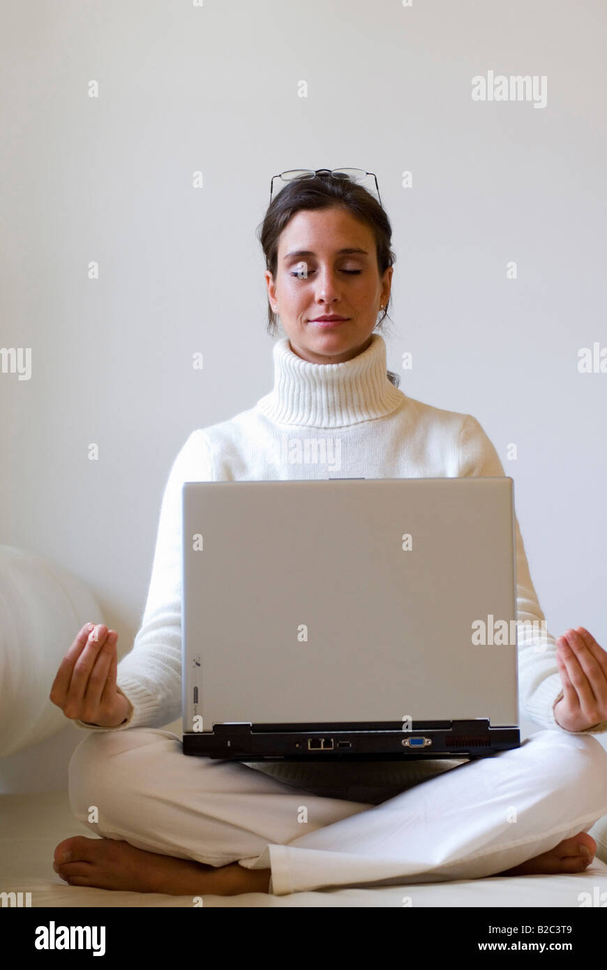 young woman practising yoga with a notebook on her lap Stock Photo - Alamy