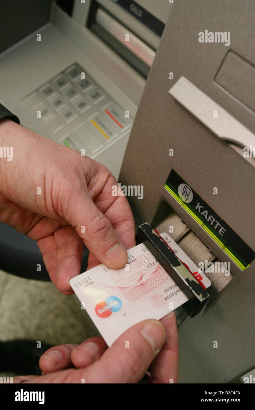 Bank employee demonstrating technical devices used by criminals to spy ...