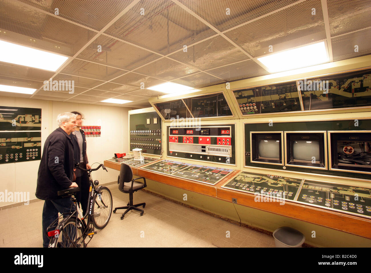 Employees observing the control room in the museum of the former ...