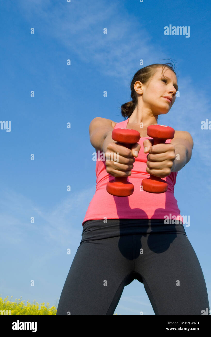 young woman lifting barbells outdoor Stock Photo - Alamy