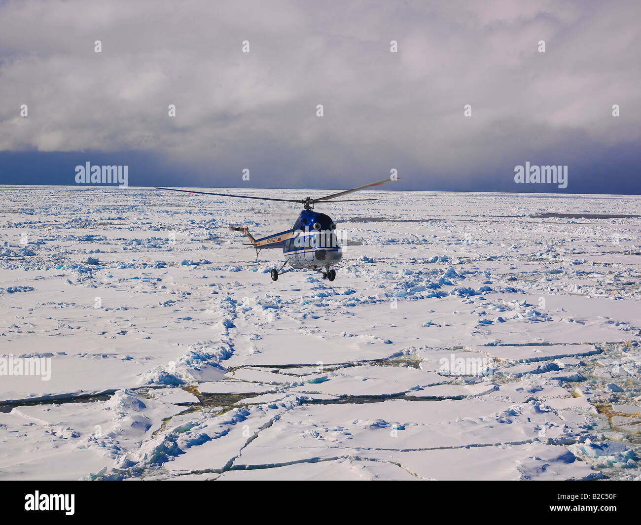 Helicopter over ocean ice, Antarctic Stock Photo - Alamy
