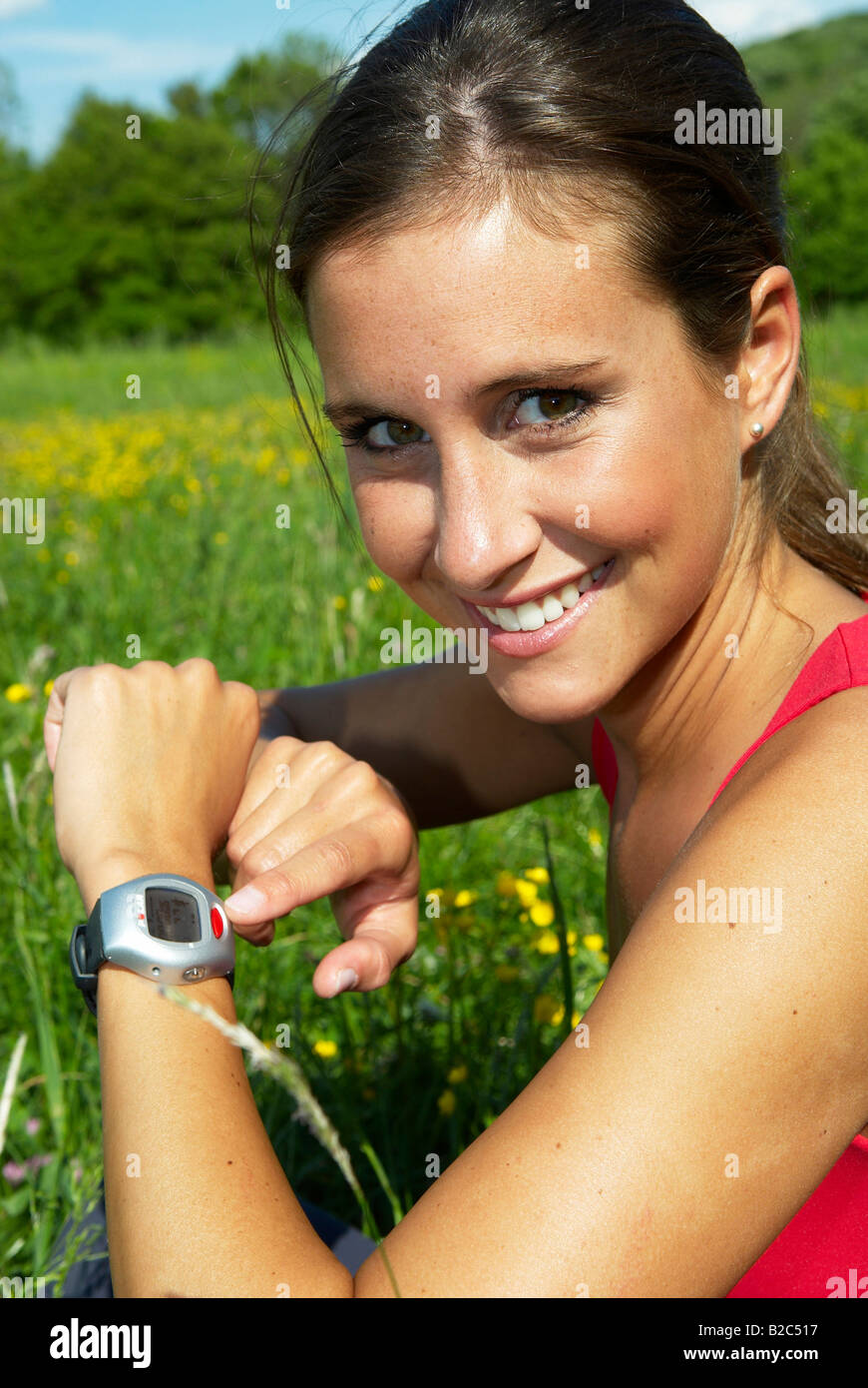 young woman running with pulse watch Stock Photo - Alamy