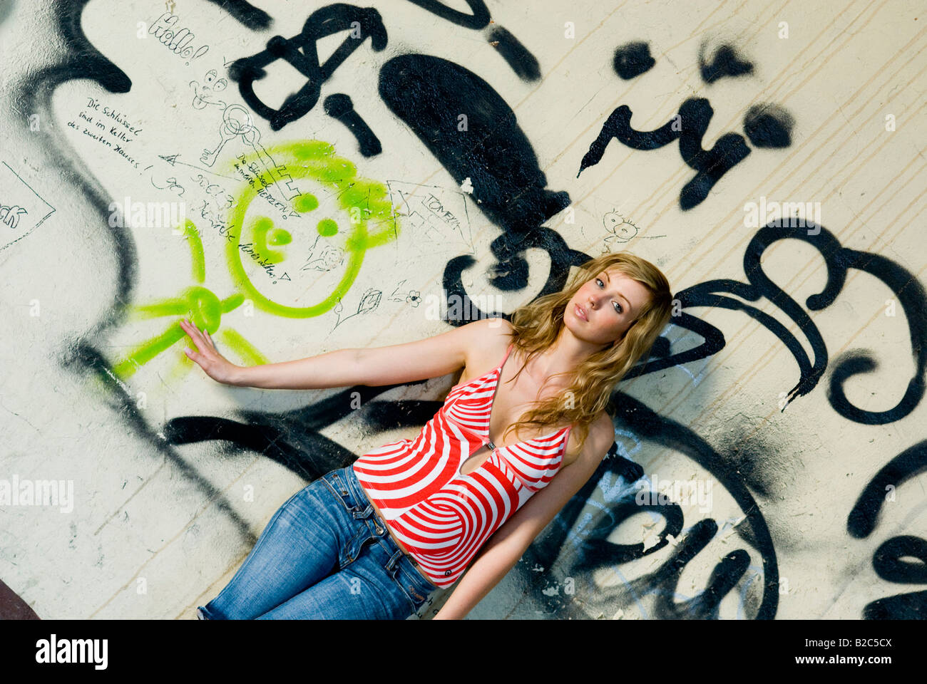 young woman holding hands with a painted graffiti man Stock Photo - Alamy