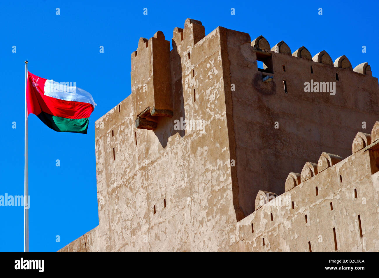 National flag of Oman fluttering in front of Jabrin Fort, Oman, Asia ...