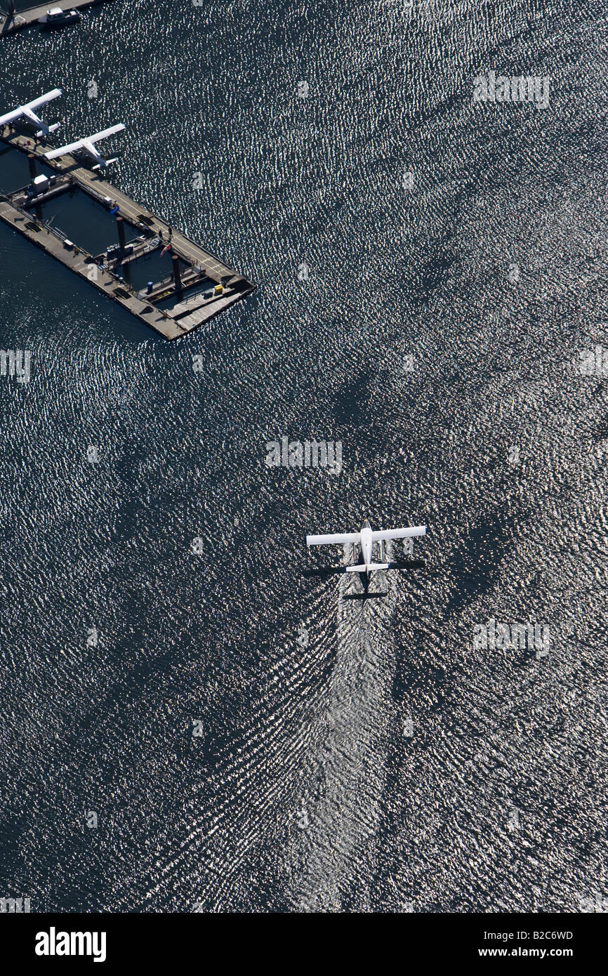Seaplane taxiing over the water toward the jetty, Vancouver, British ...