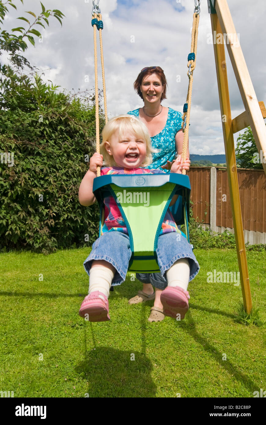 Child pushed on swing hi-res stock photography and images - Alamy