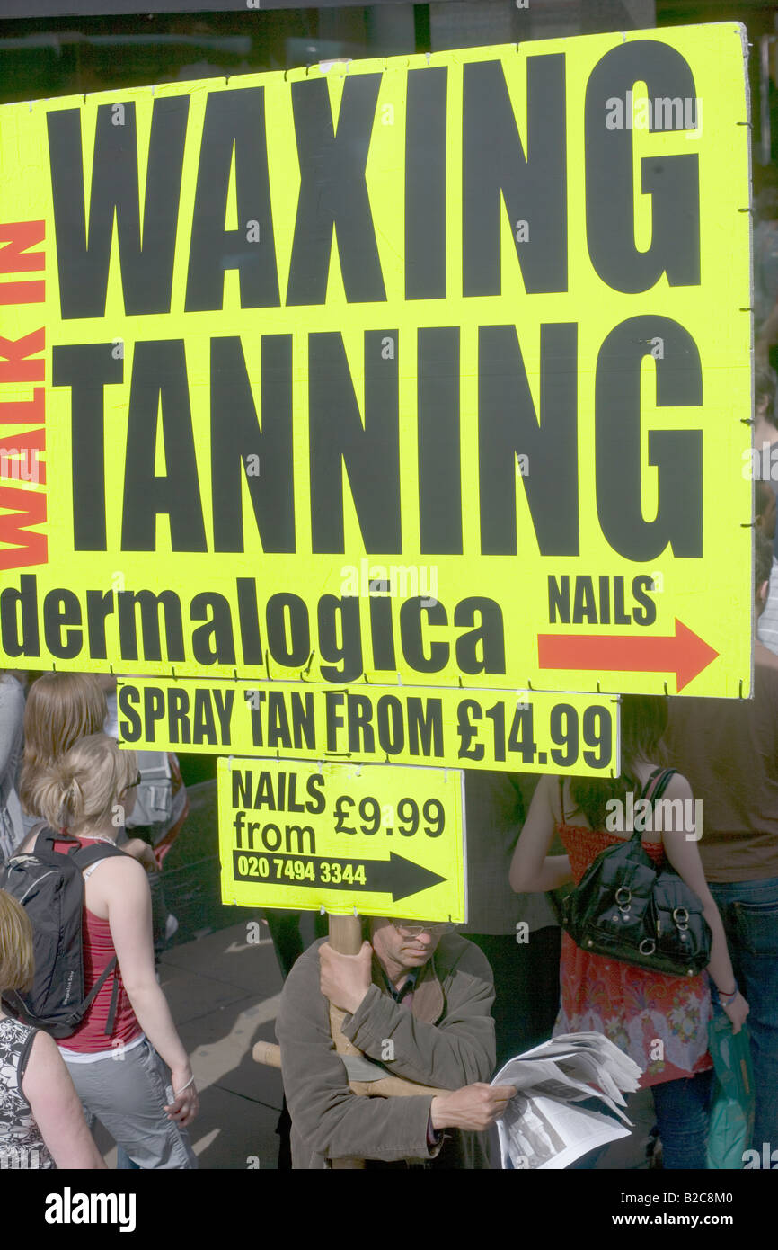 Sign advertising placard sign supported carried by man hi-res stock ...