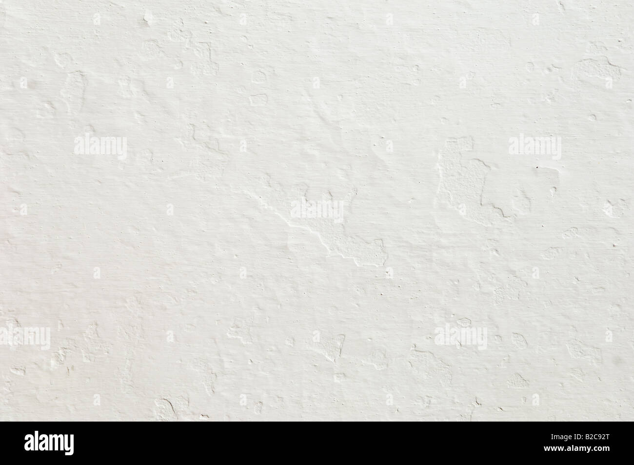 Detail of a rugged white wall suitable as background Stock Photo - Alamy