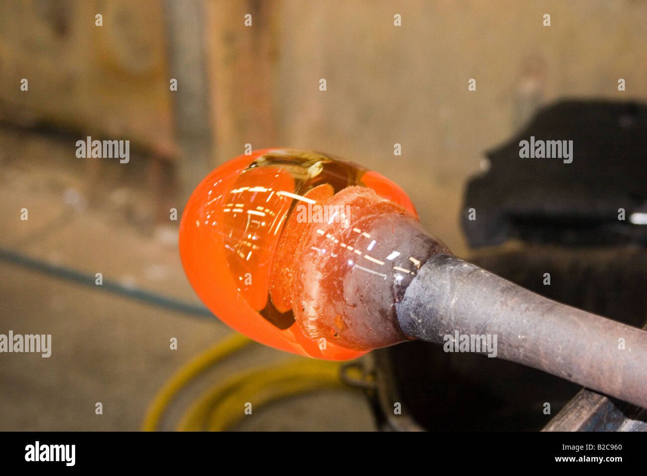 End of rod with molten glass used by glass blower worker. red hot ...
