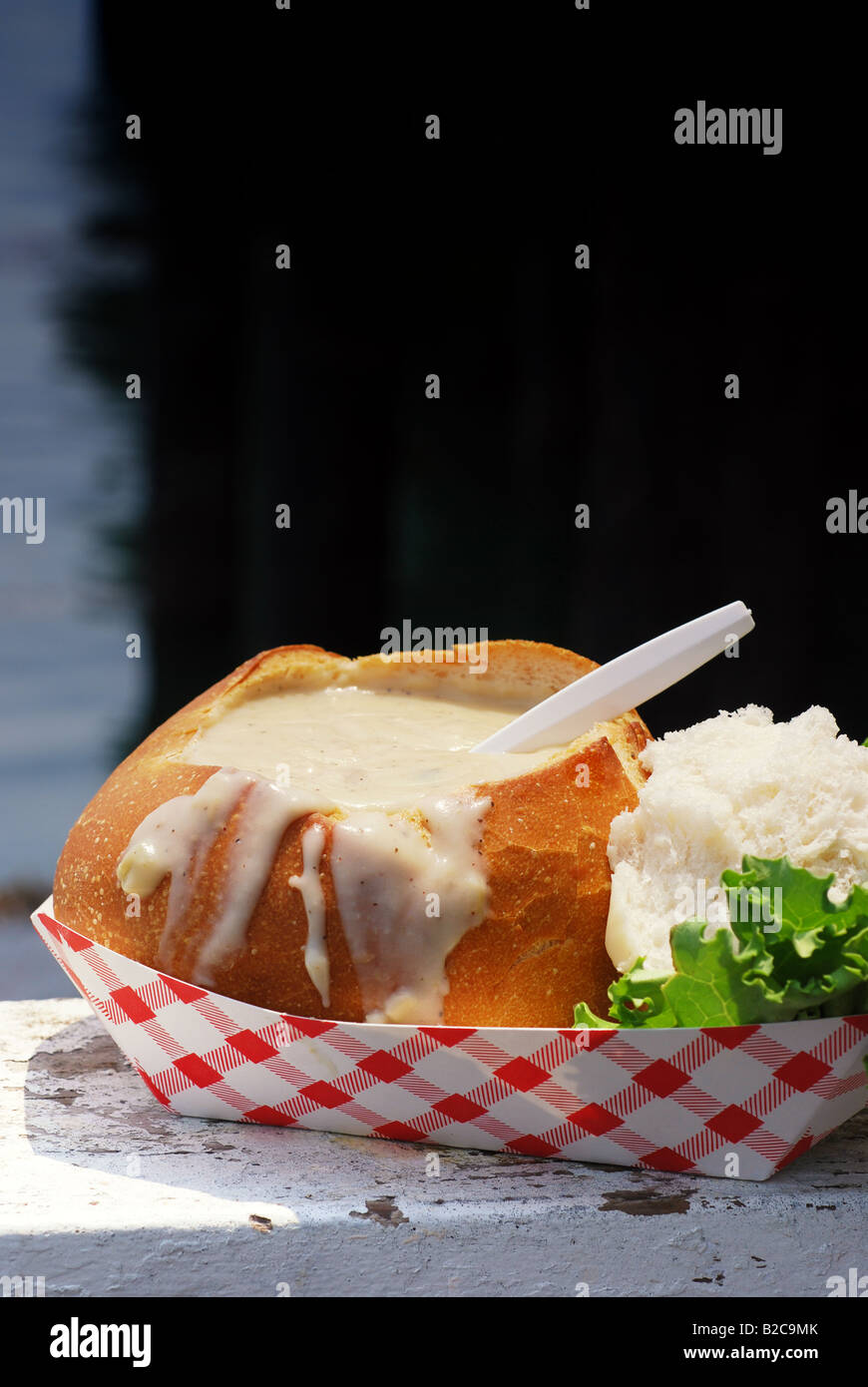 Clam chowder in a sourdough bread bowl on a wooden fishing dock Stock ...