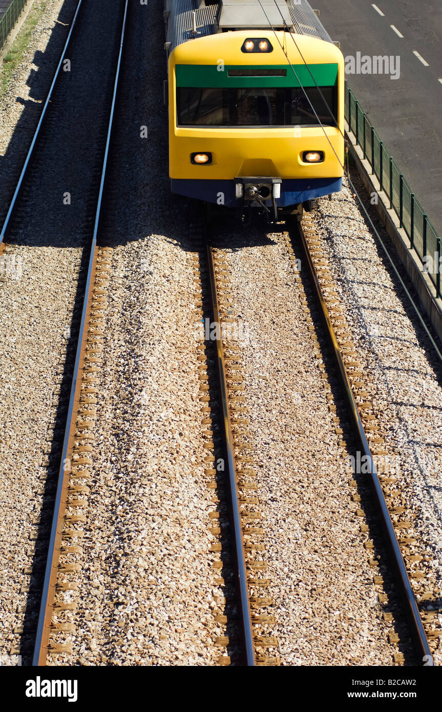 Oncoming suburban train on railway tracks Stock Photo - Alamy