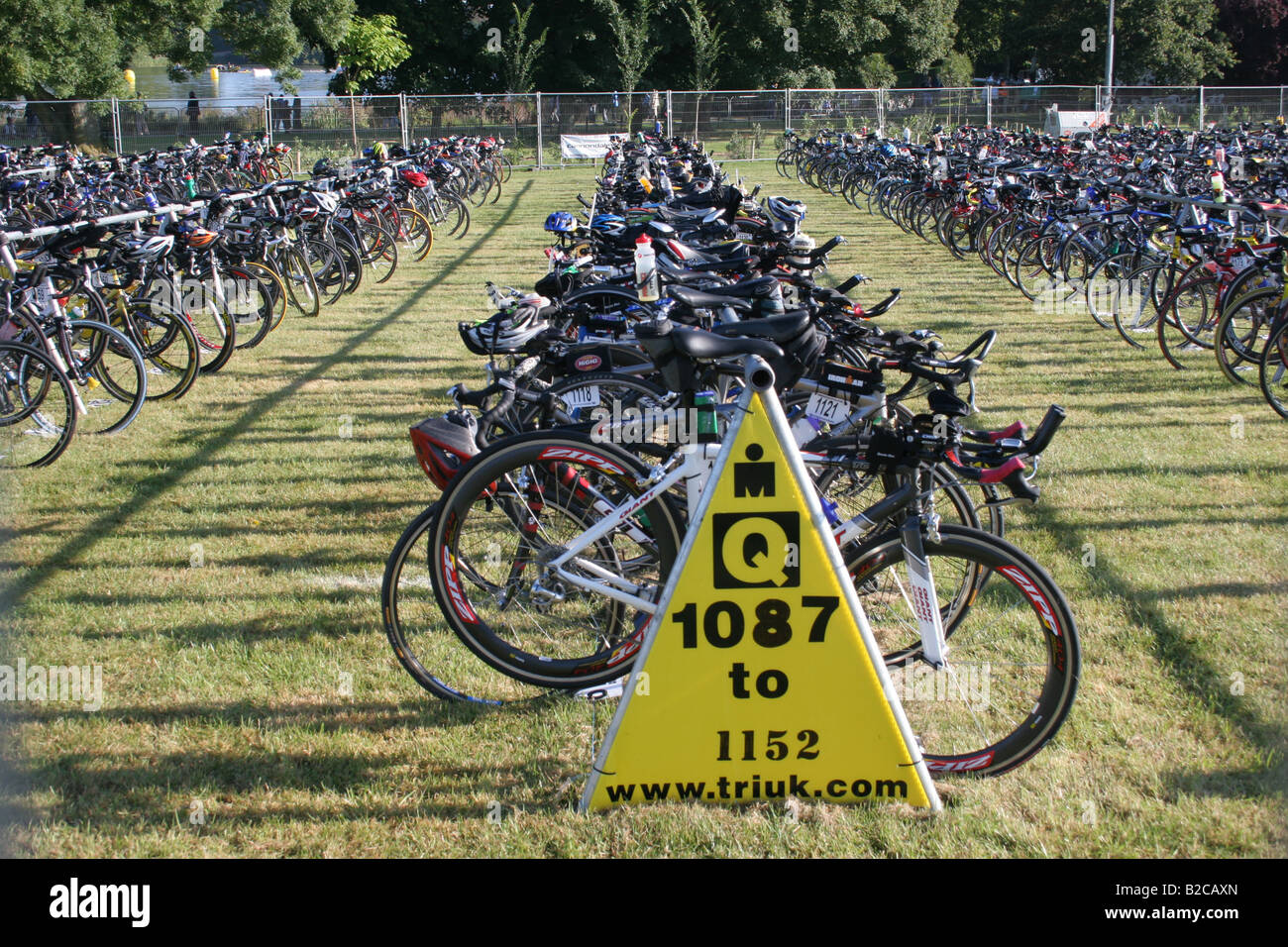 racing bycicles push bykes on transition at Ironman competition in ...