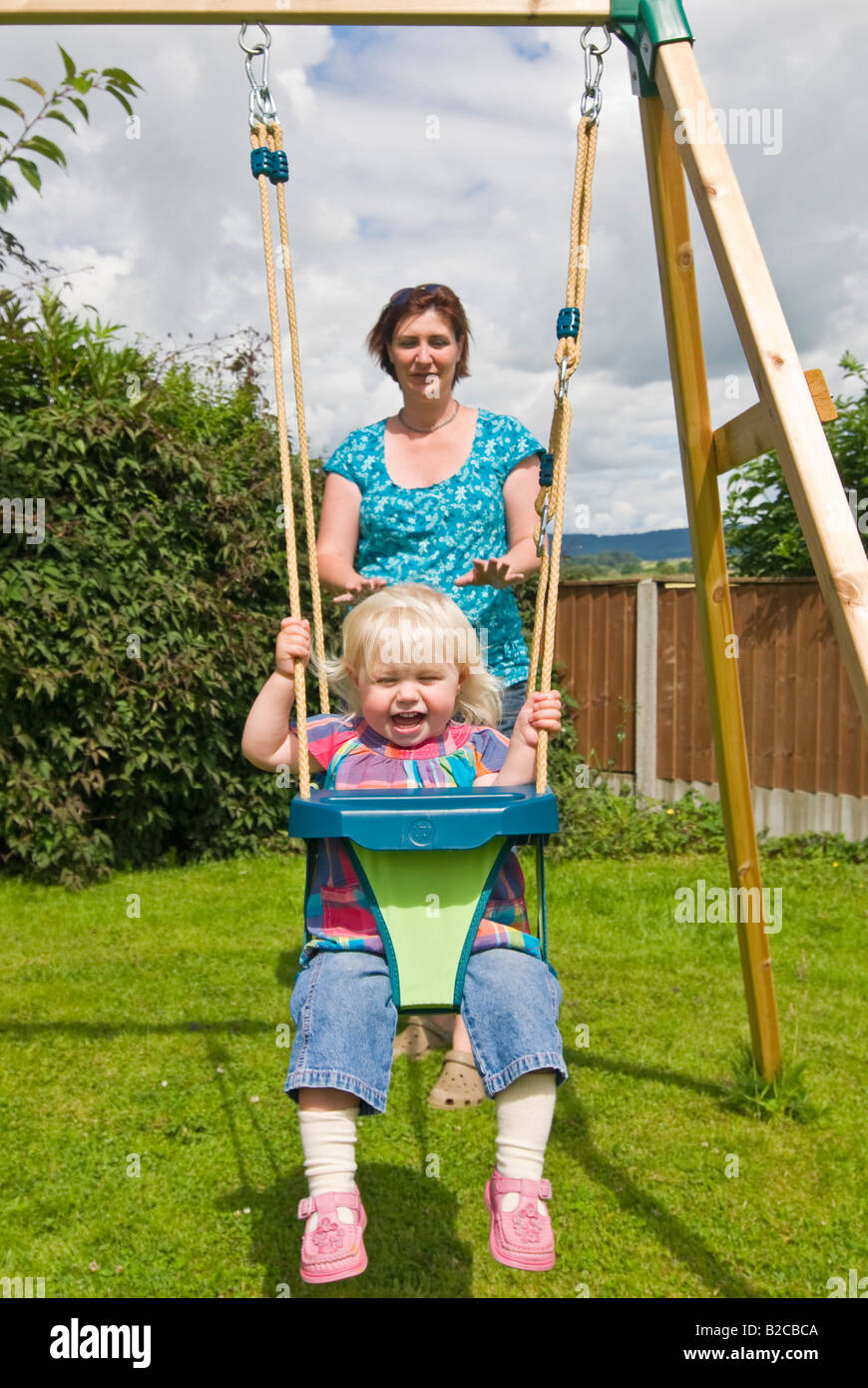 Woman being pushed on swing hi-res stock photography and images - Alamy