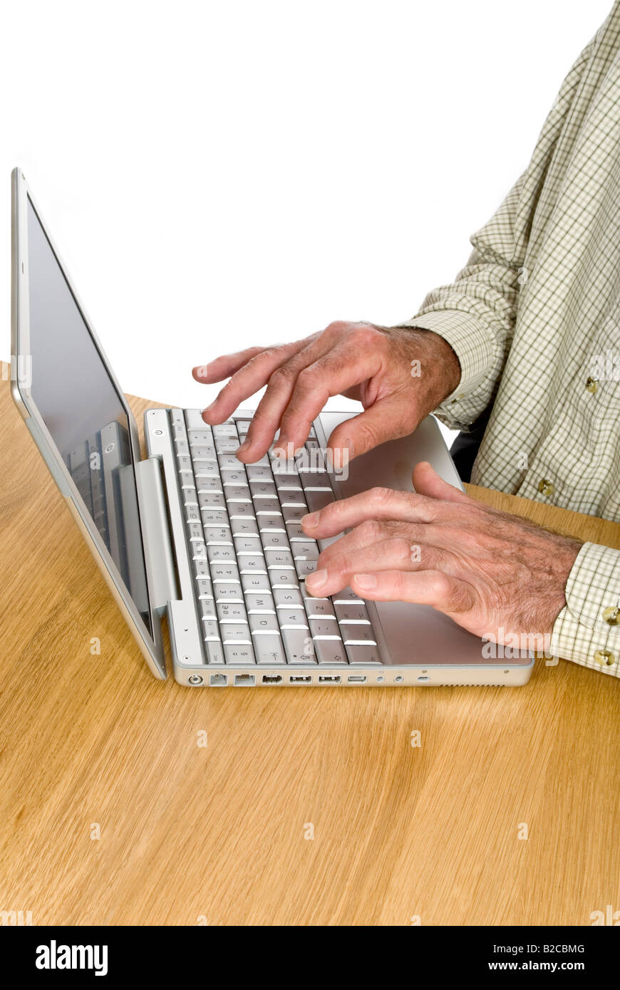 Vertical portrait of an elderly gentleman surfing the internet on his ...
