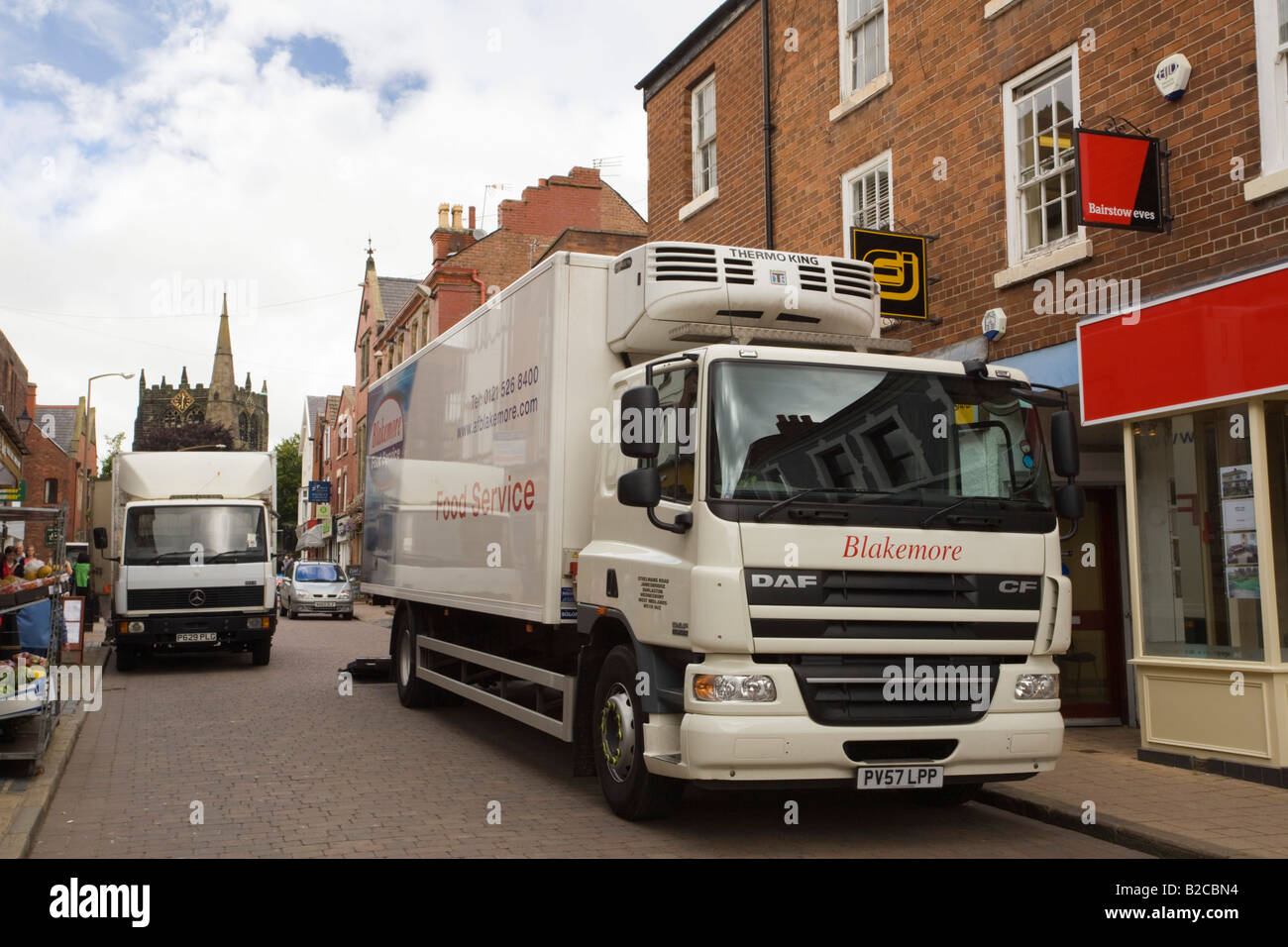 Delivery van and lorry blocking narrow road in town centre. Ormskirk ...