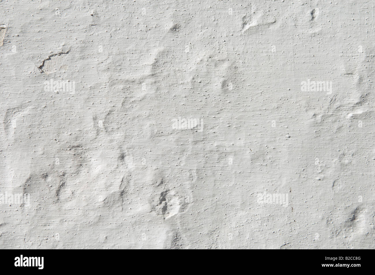 Detail of a rugged white wall suitable as background Stock Photo - Alamy