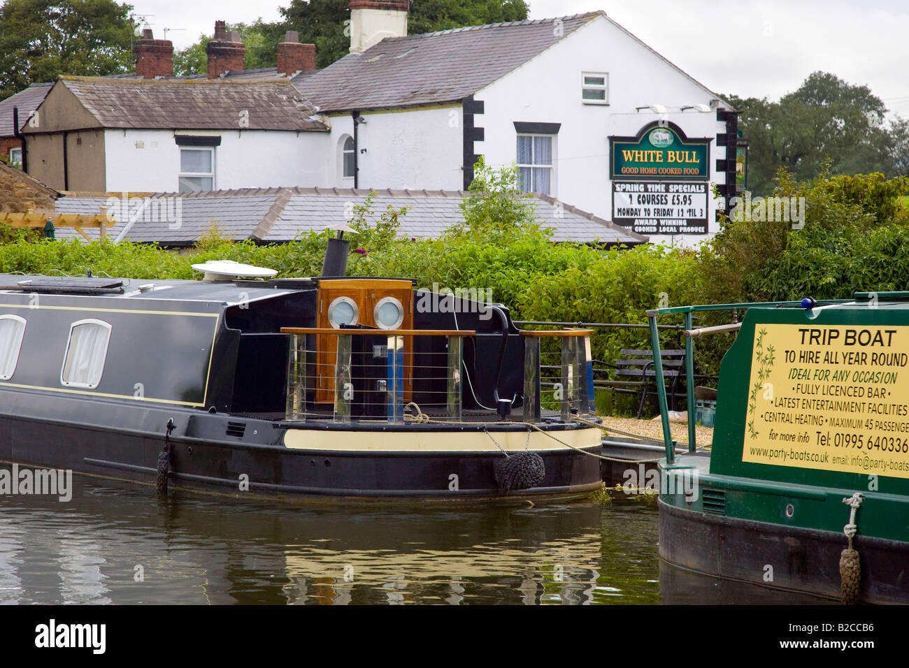 Colourful houseboats moored along canal banks at Bilsborrow Moorings ...