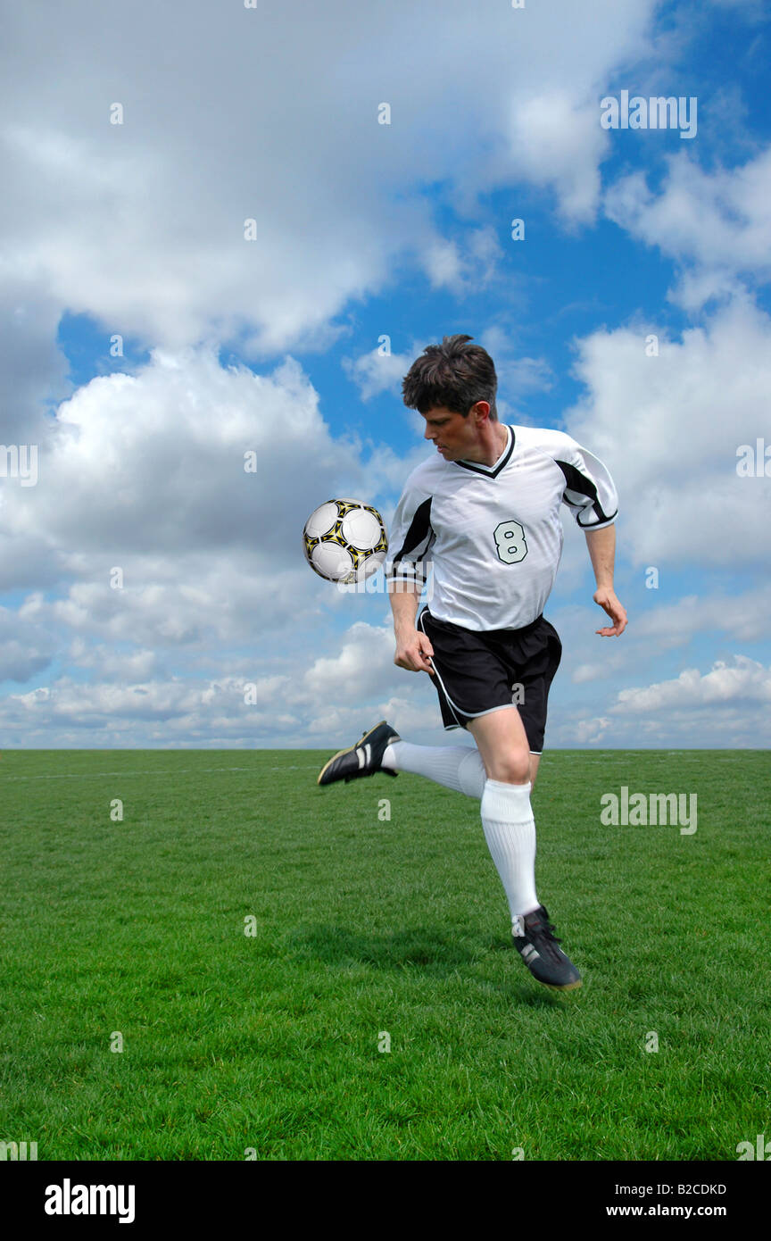 Soccer player performing a back kick over a colorful background Stock ...