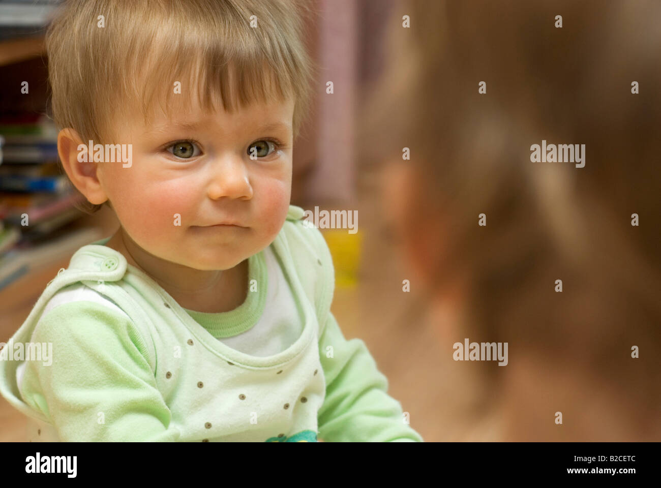 Little Child Looking at Other Kid Indoors Stock Photo - Alamy