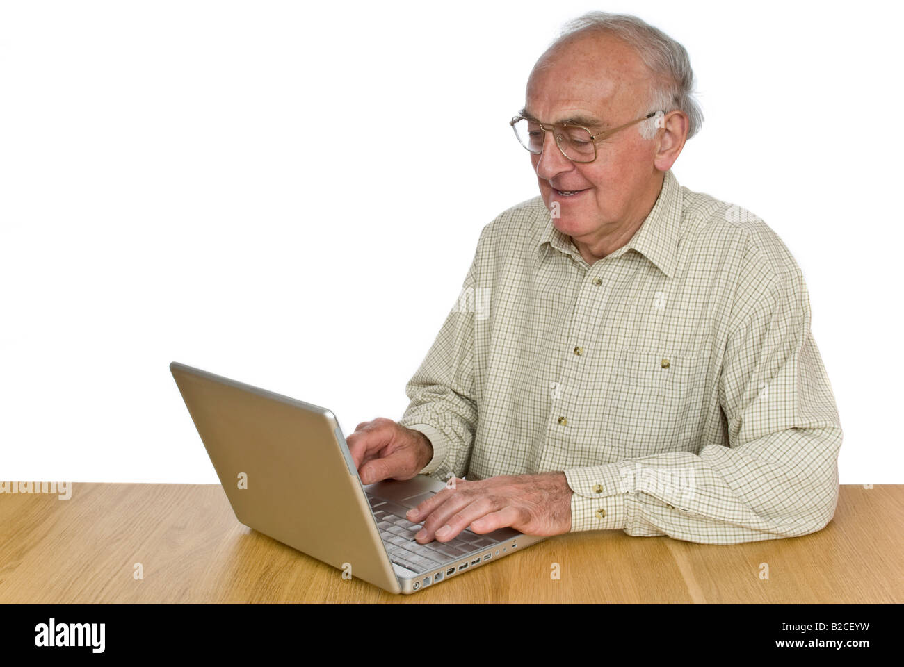 Horizontal portrait of an elderly gentleman surfing the internet on his ...