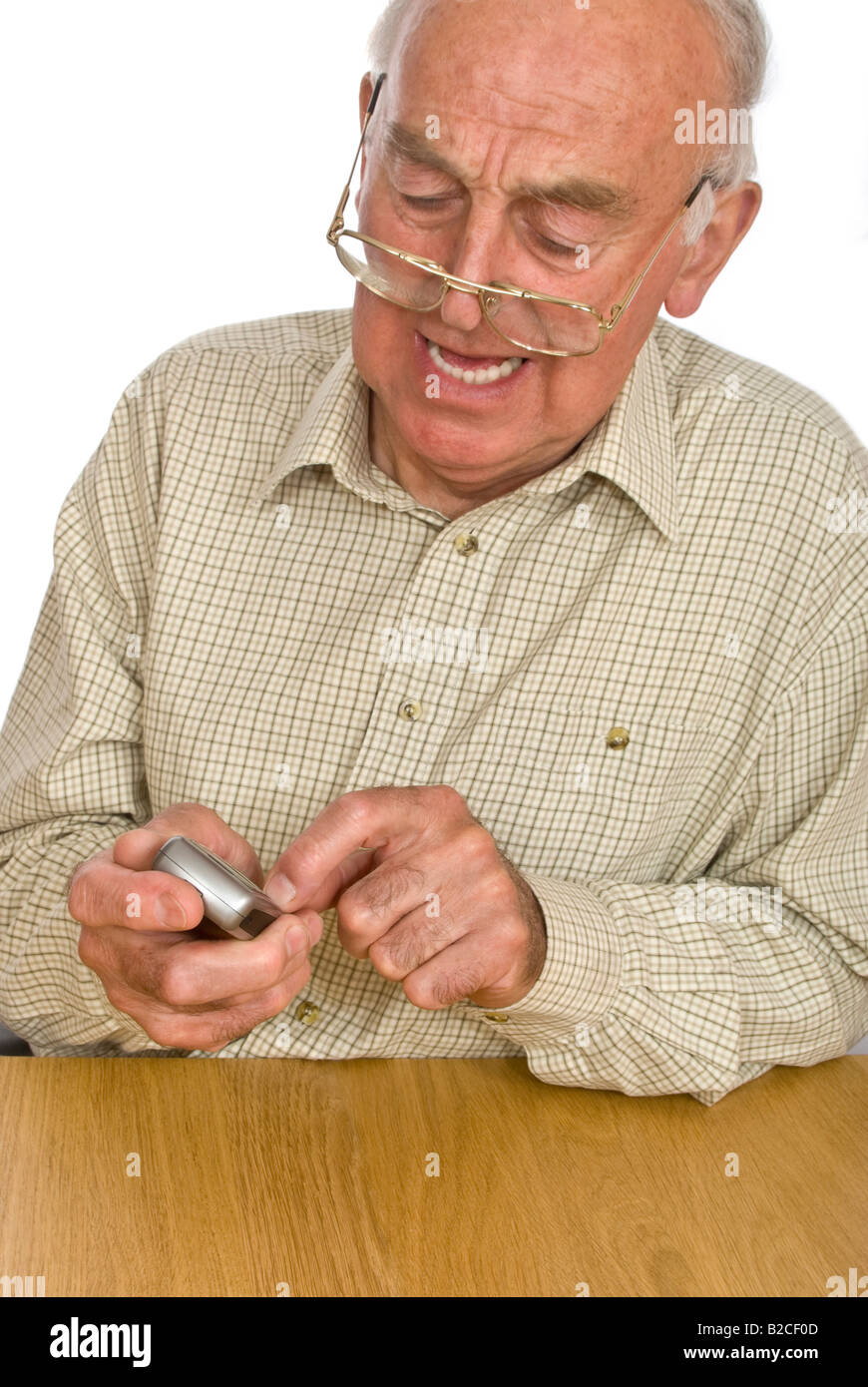 Vertical portrait of an elderly gentleman getting frustrated using the ...