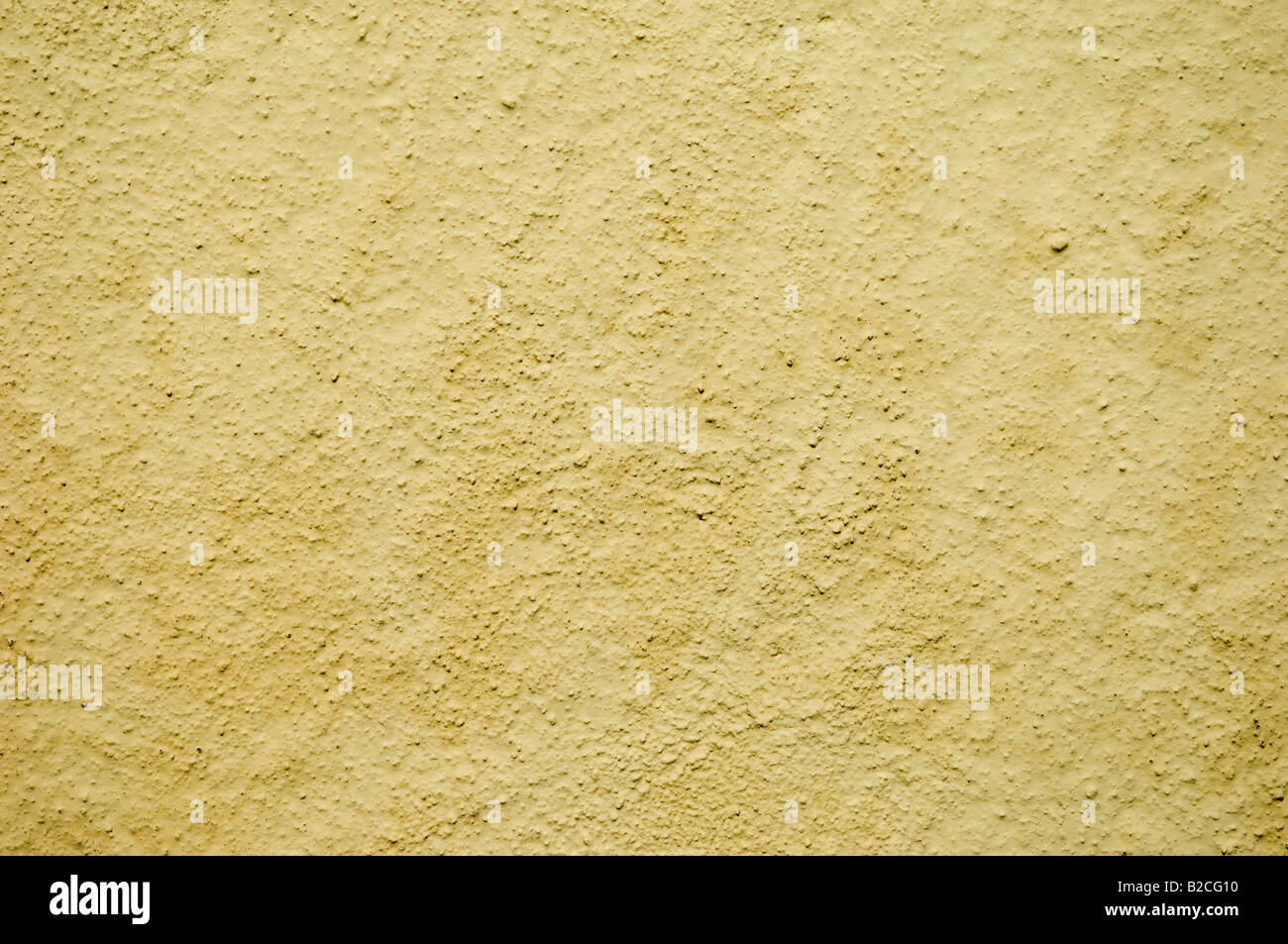 Detail of a rugged yellow wall Stock Photo - Alamy