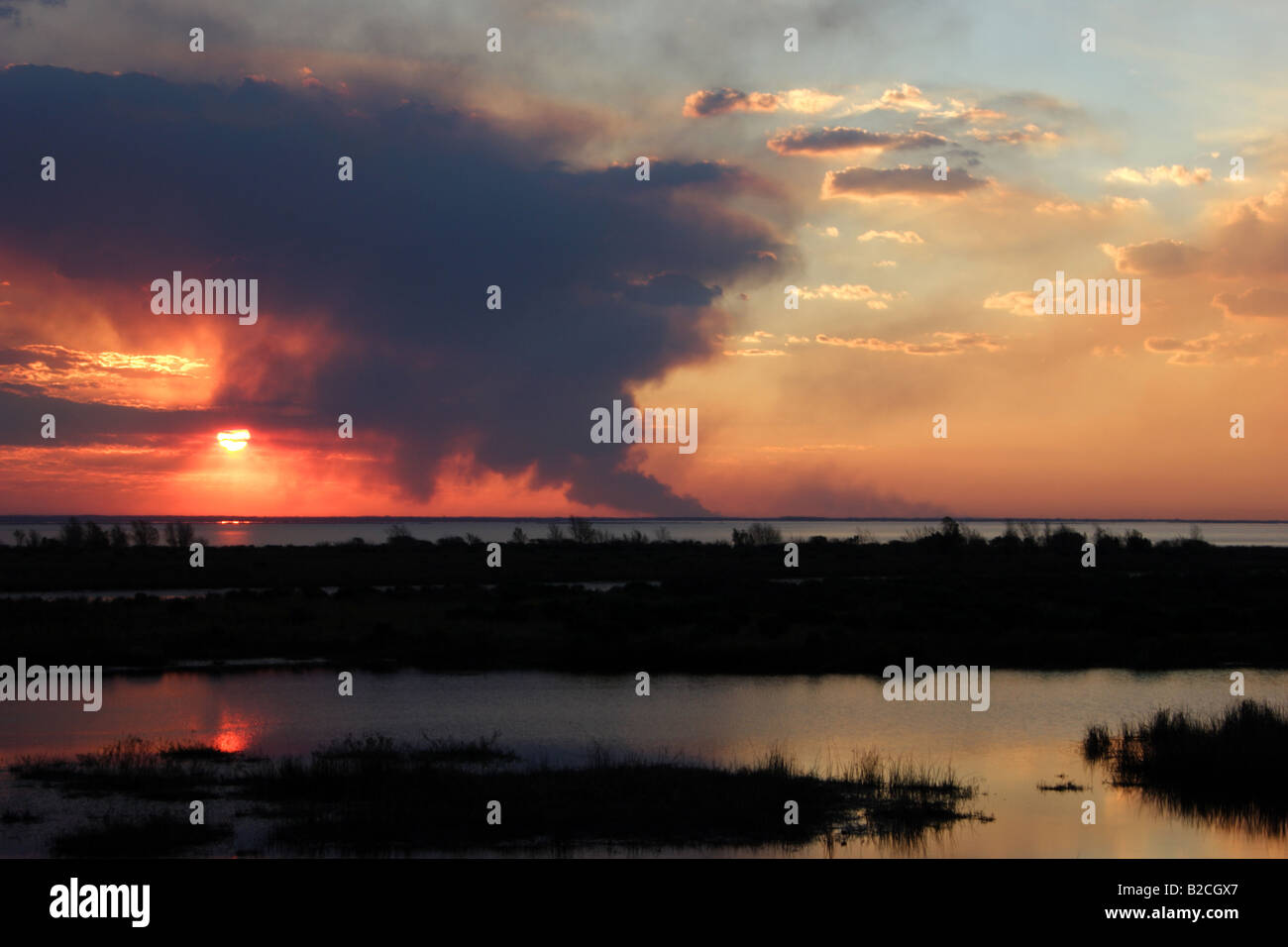 Sunset over the Delta with smoke 2 Stock Photo - Alamy