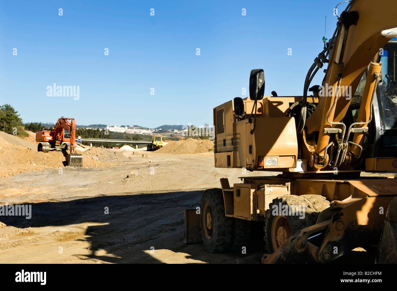 Excavators in a road construction site Stock Photo - Alamy