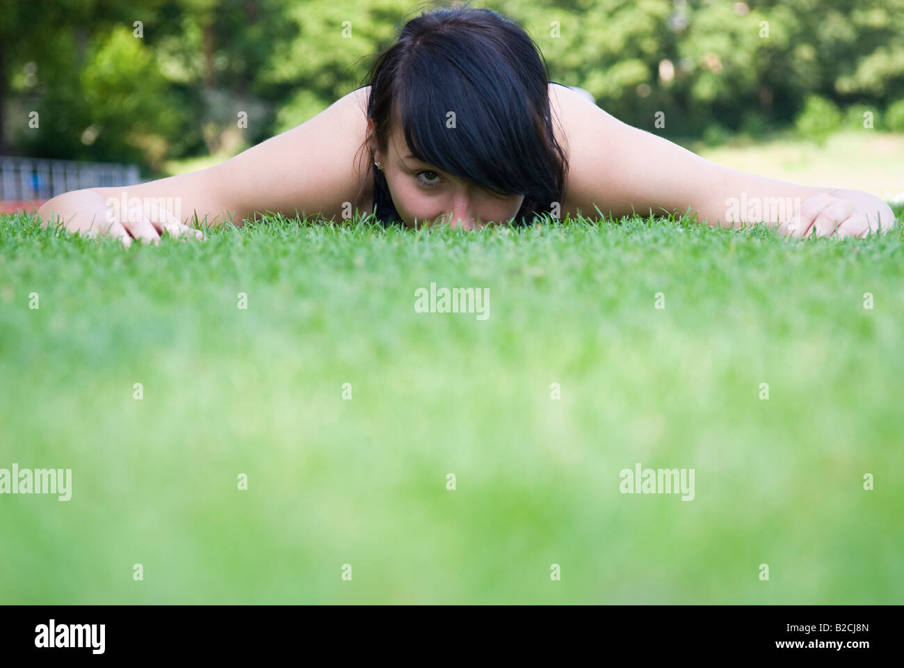 young woman doing push-ups on a lawn, exhausted Stock Photo - Alamy