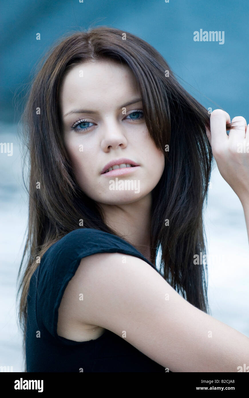 young woman grasping in her hair Stock Photo - Alamy