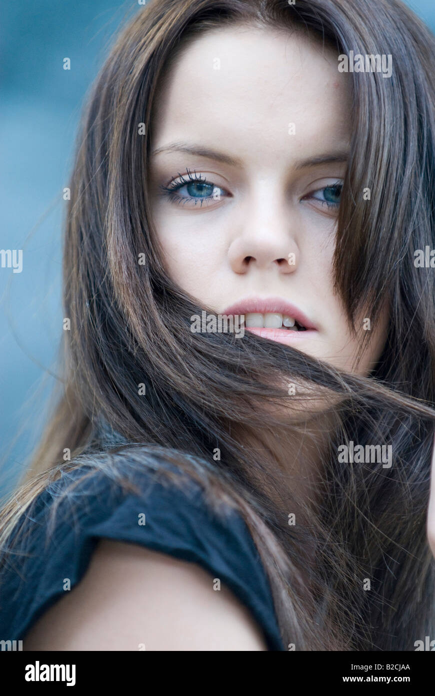 young woman grasping in her hair Stock Photo - Alamy
