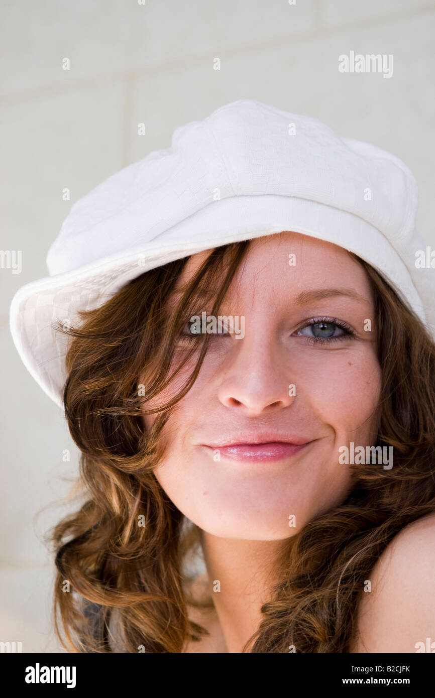 young pretty woman with white cap, smiling Stock Photo - Alamy
