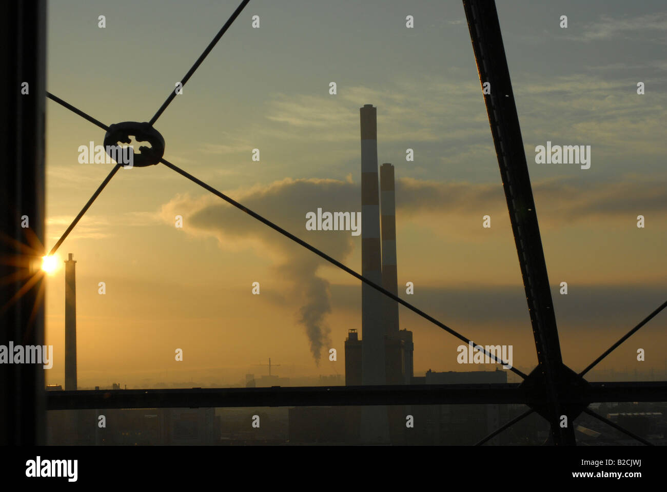 chimneys with factory fumes at sunset Stock Photo - Alamy