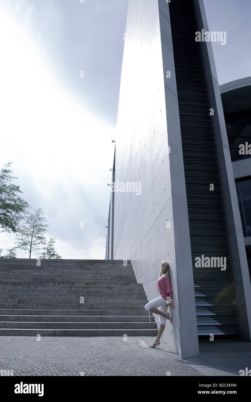 young woman posing in front of a modern building Stock Photo - Alamy