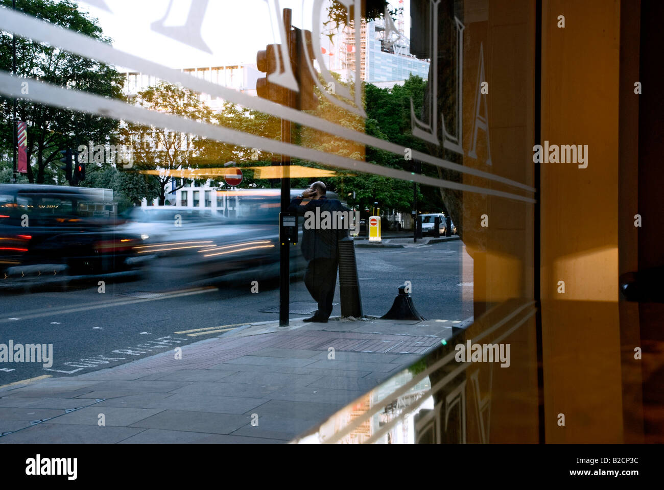 Man on mobile phone standing by fast moving traffic Stock Photo - Alamy