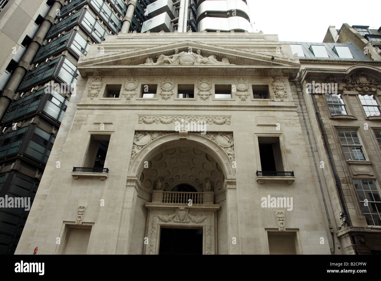 Lloyds of London old building entrance with new Lloyds building in ...