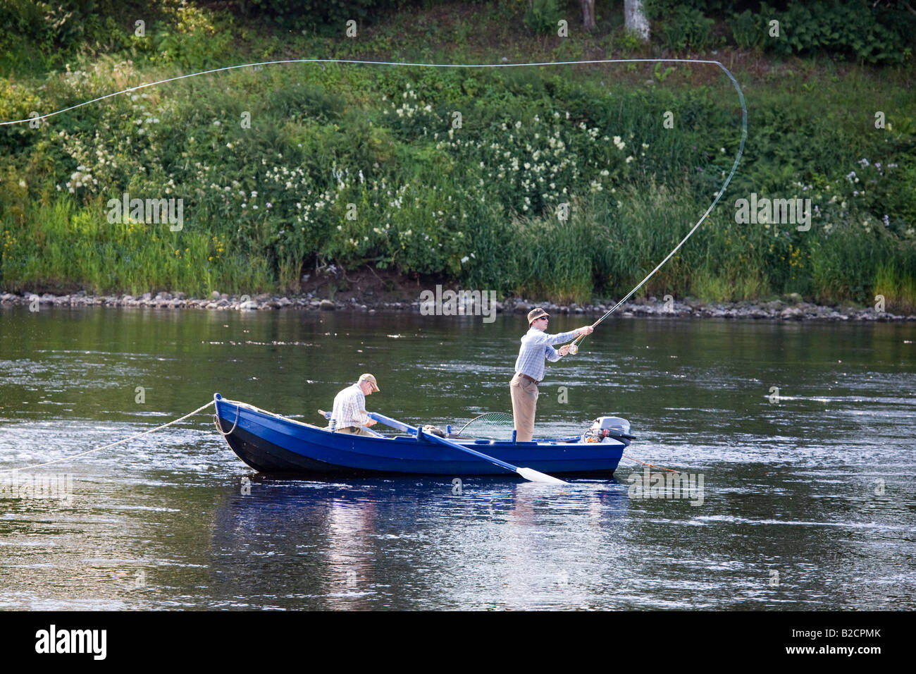 Vacations two men fishing rowing boat hi-res stock photography and ...
