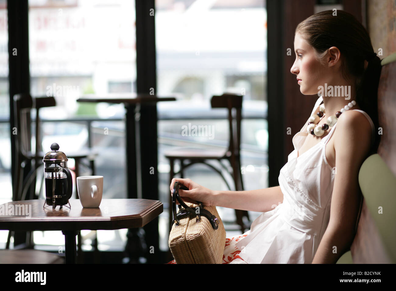 Woman sitting in café hi-res stock photography and images - Alamy