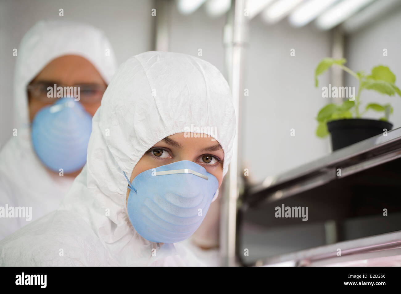 Workers in protective masks and suits in laboratory, portrait Stock ...