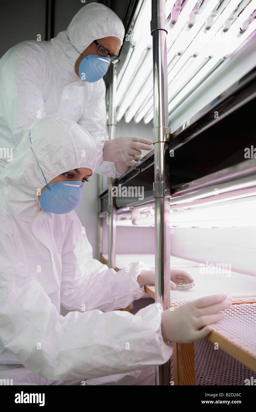 Workers in protective masks and suits in laboratory Stock Photo - Alamy