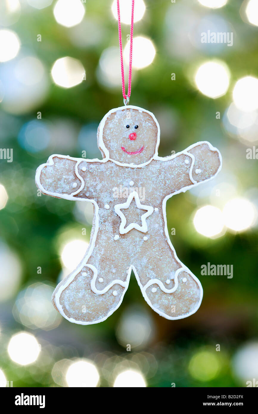Gingerbread man hanging against Christmas lights Stock Photo - Alamy
